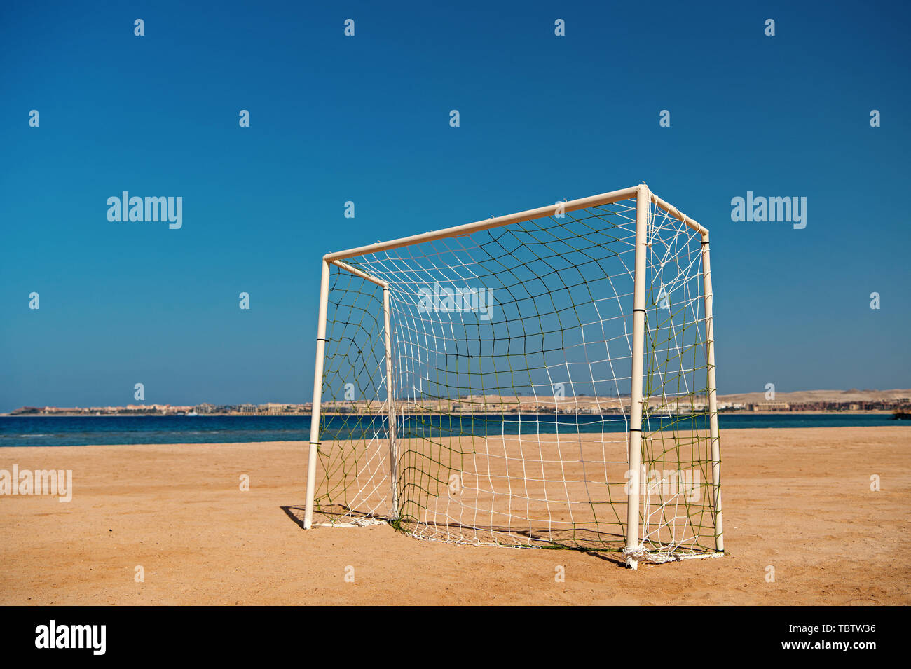 Soccer or football gate with net on sand beach blue sky and sea ...