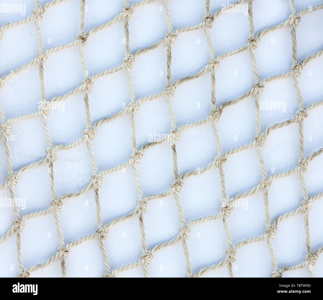 A rope mesh on a white substrate background template Stock Photo - Alamy