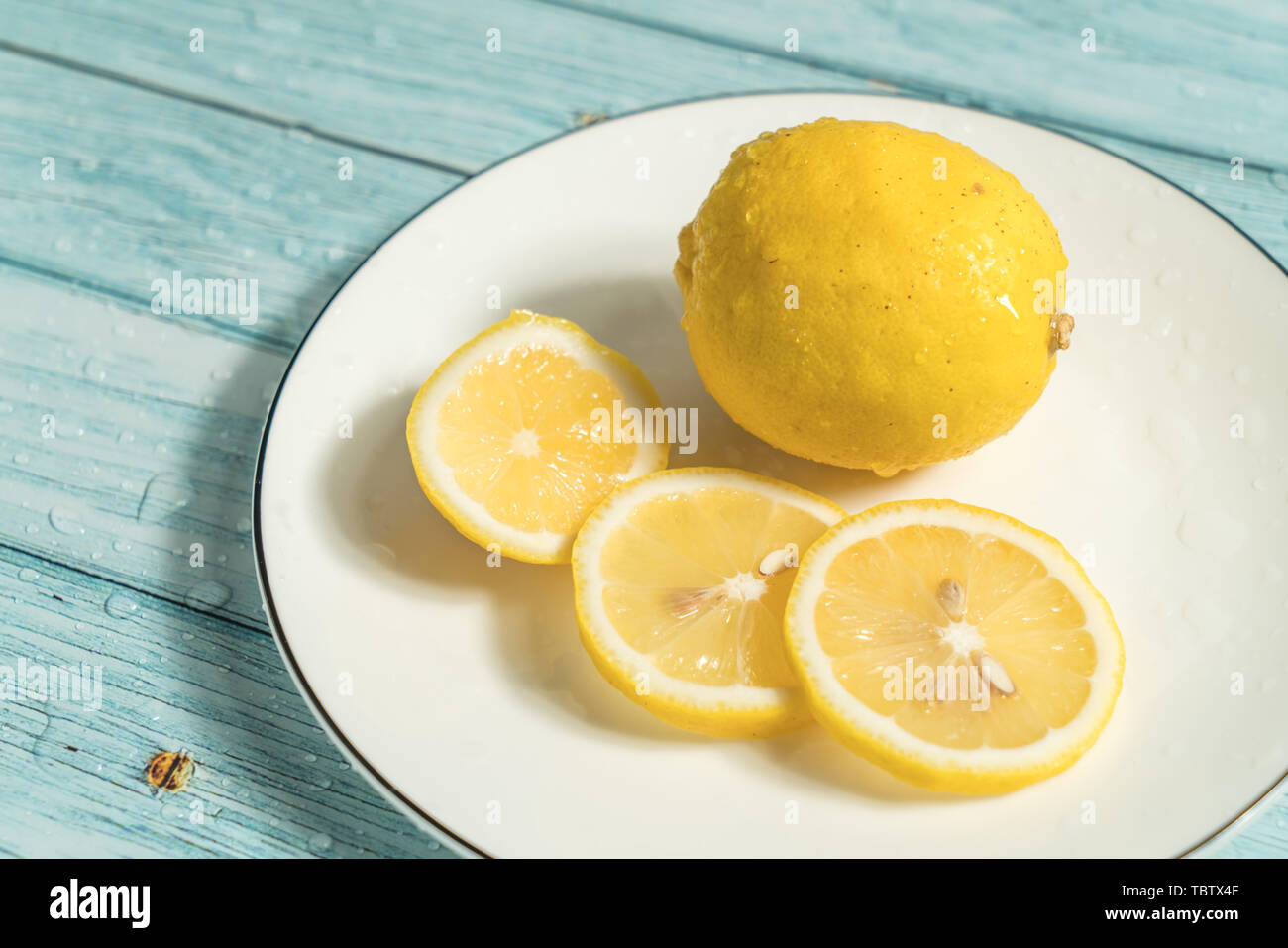 Lemon with teal wood pattern background Stock Photo - Alamy