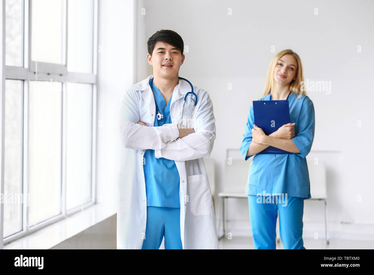 Male doctor and female medical assistant in clinic Stock Photo - Alamy
