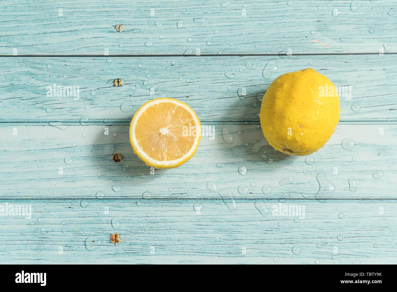 Lemon with teal wood pattern background Stock Photo - Alamy