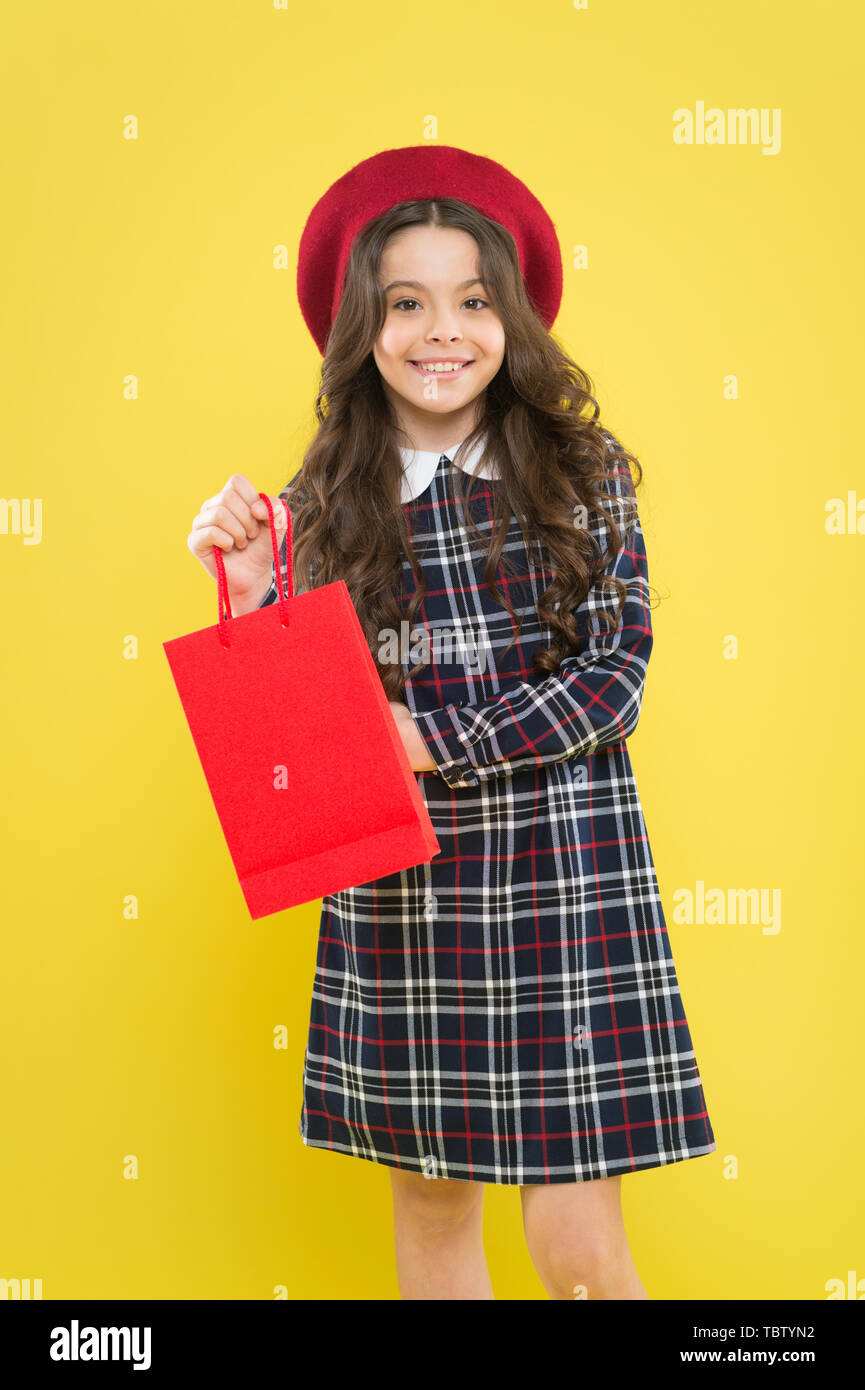 Purchase the trend. Little girl smiling with personal purchase on ...