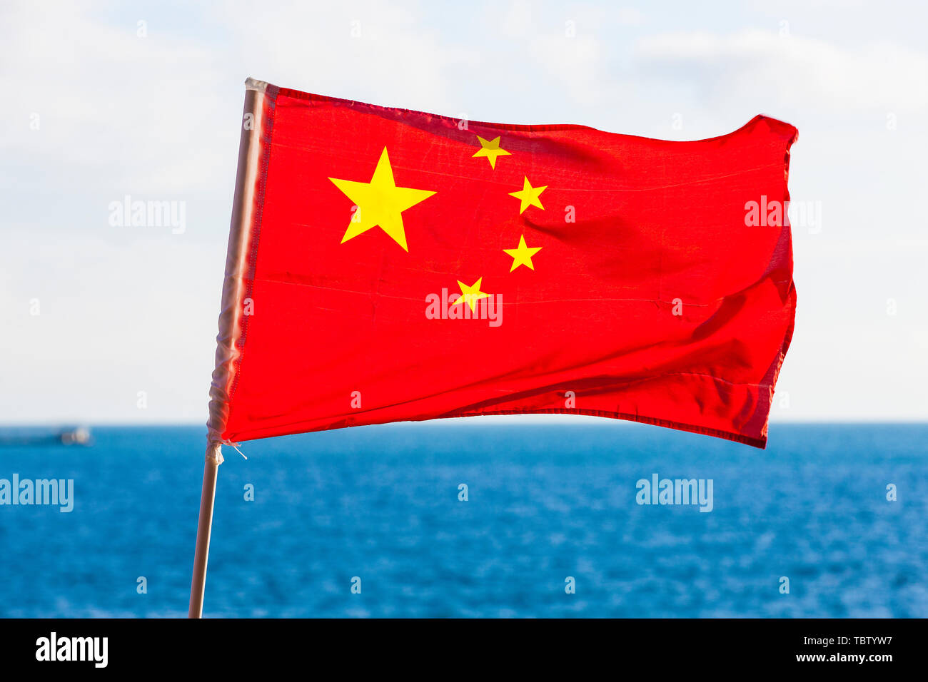 Chinese National Flag Against Blue sea Stock Photo - Alamy