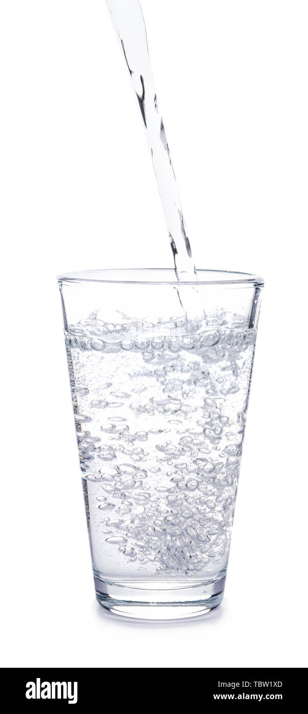 Pouring of water into glass on white background Stock Photo - Alamy
