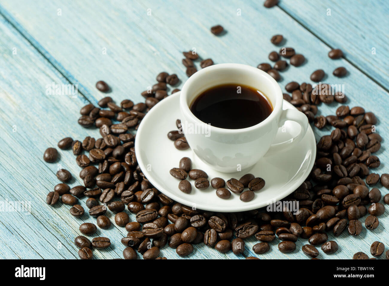 Coffee and coffee beans on a light blue background Stock Photo - Alamy