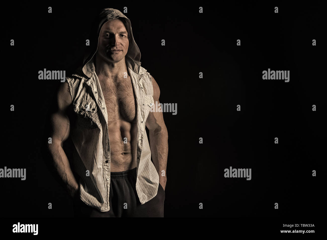 Sportsman show biceps and triceps in sleeveless shirt. Man athlete wear ...