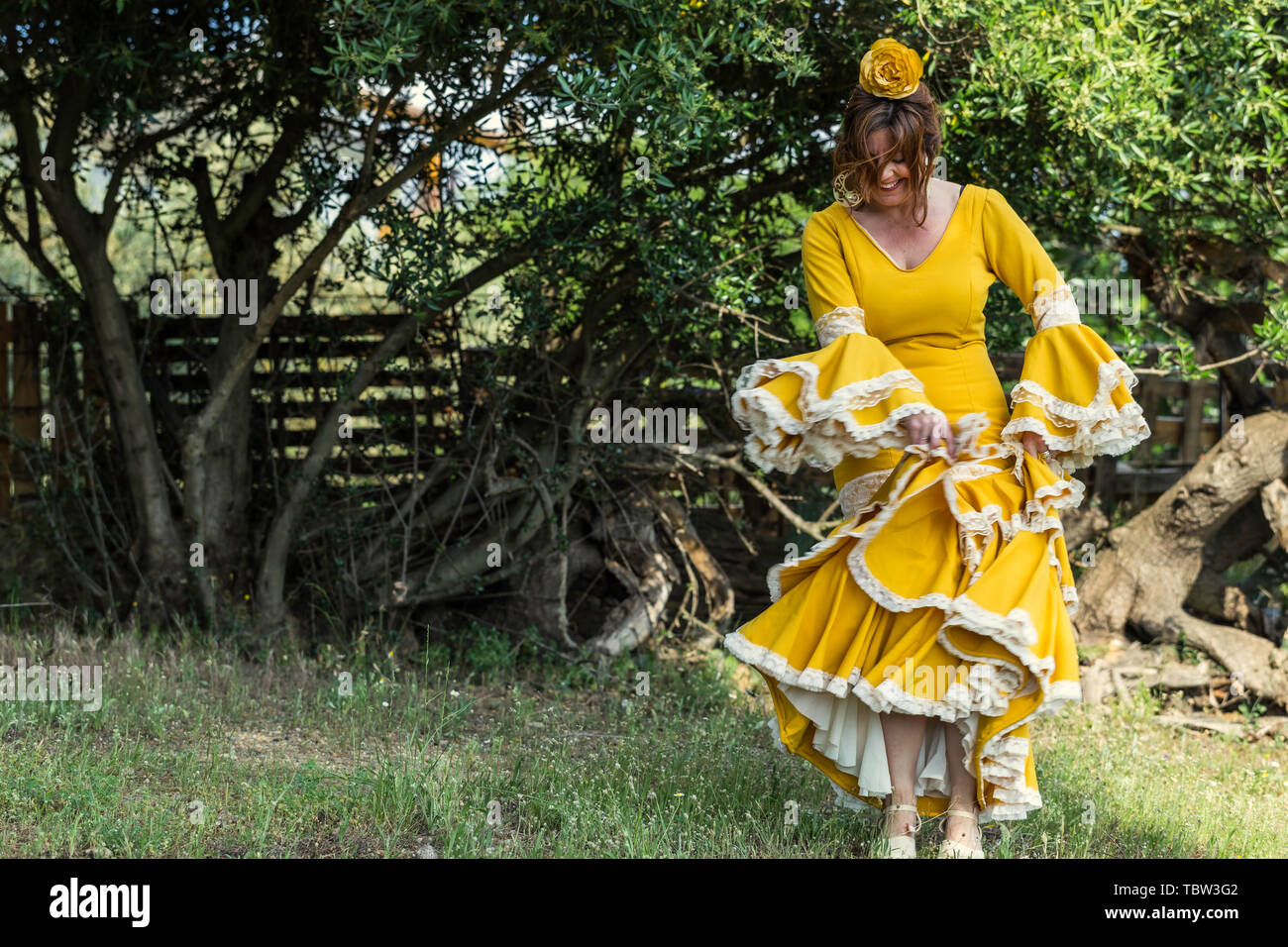 Woman traditional dancer wearing yellow flamenco dress,dancing outside ...