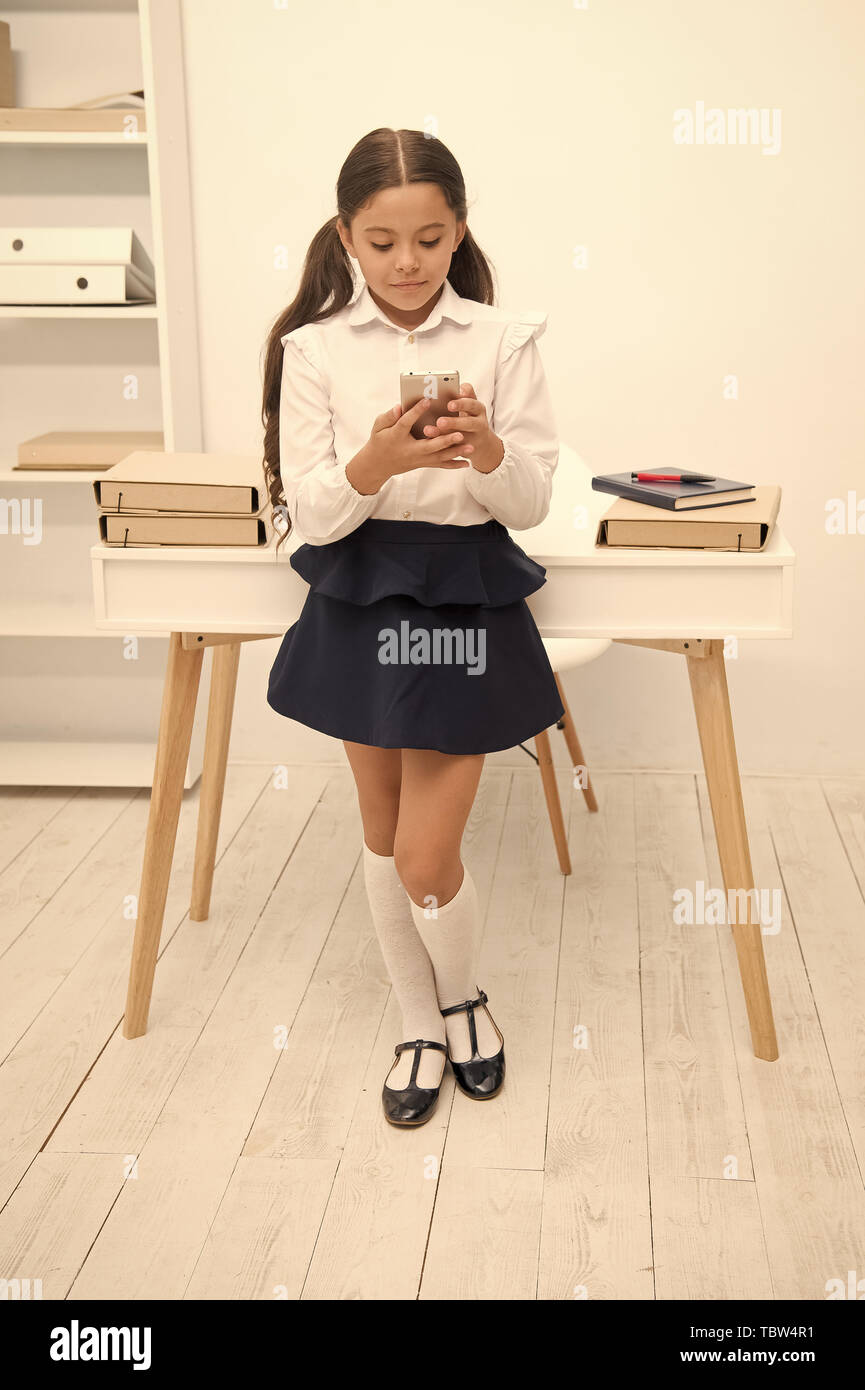 Always in touch. Kid girl send message to parents. Schoolgirl smiling ...