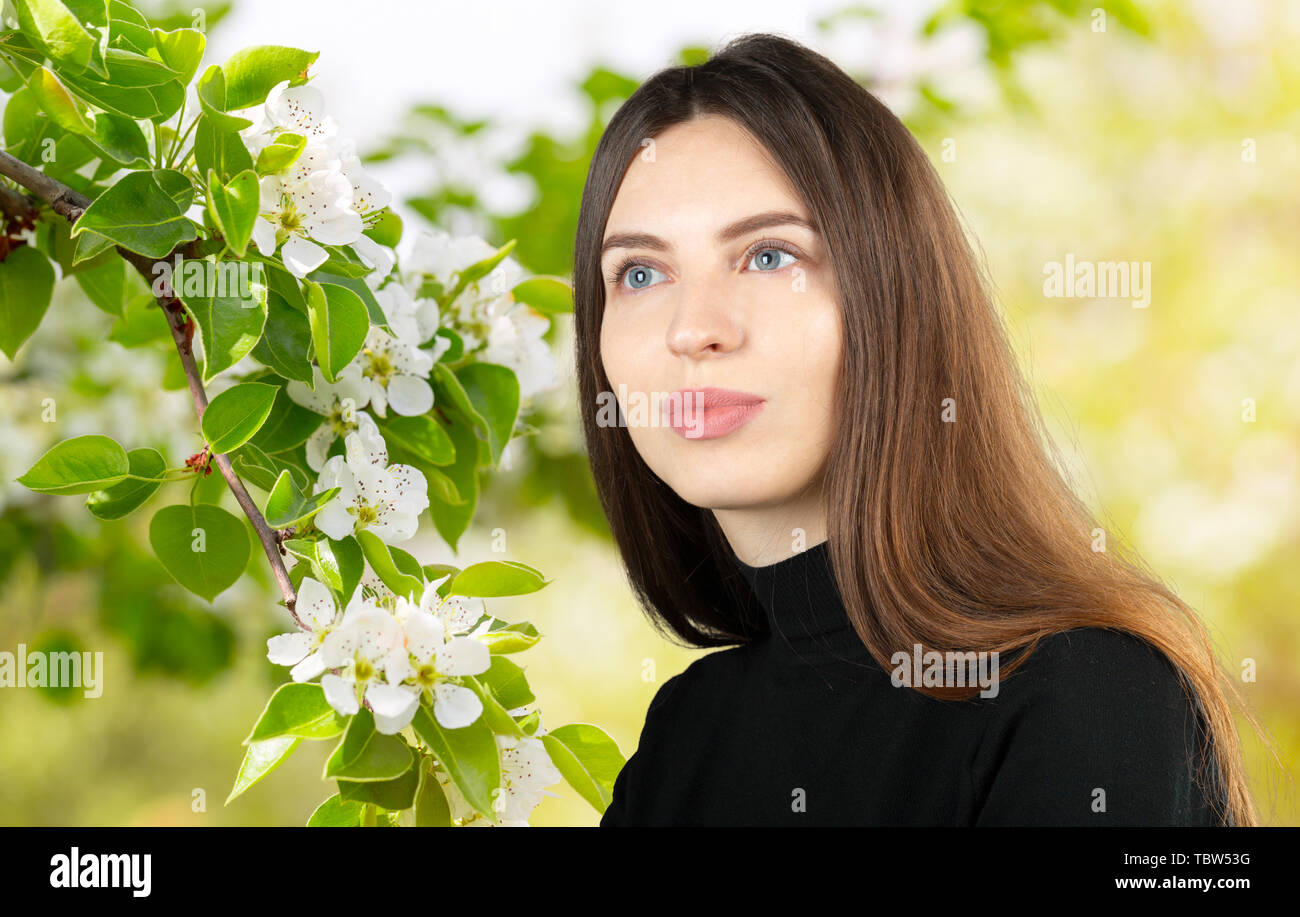 Studio portrait of beautiful young woman thinking and looking upwards ...