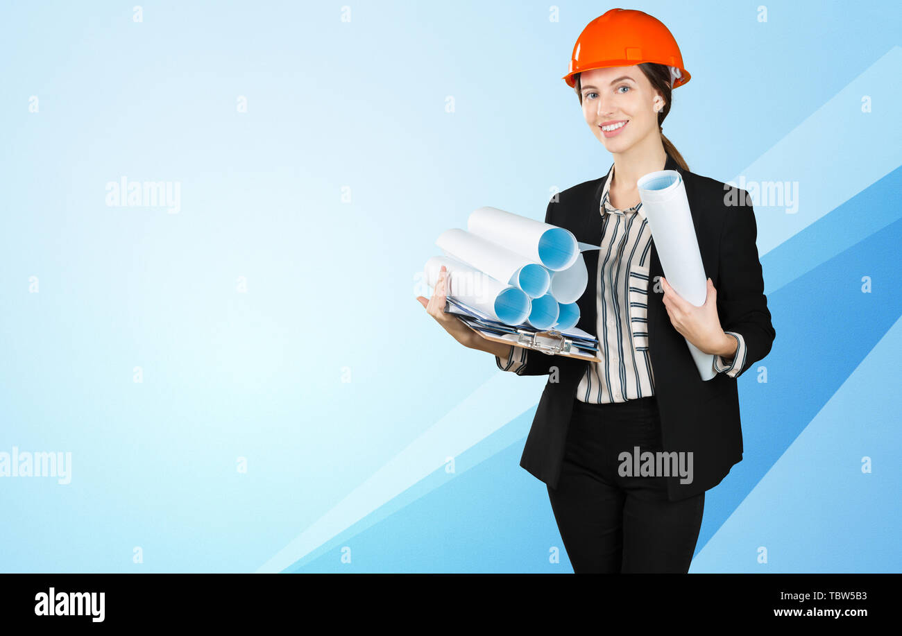 Portrait of a young female engineer wearing a safety helmet at work ...