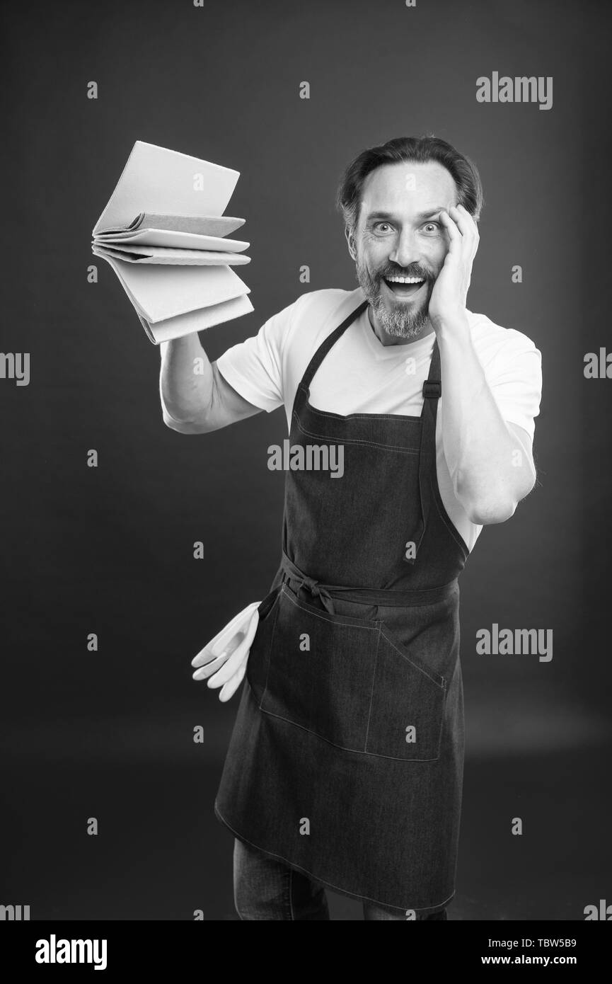 Cleaning service and household duty. Man in apron with gloves hold ...