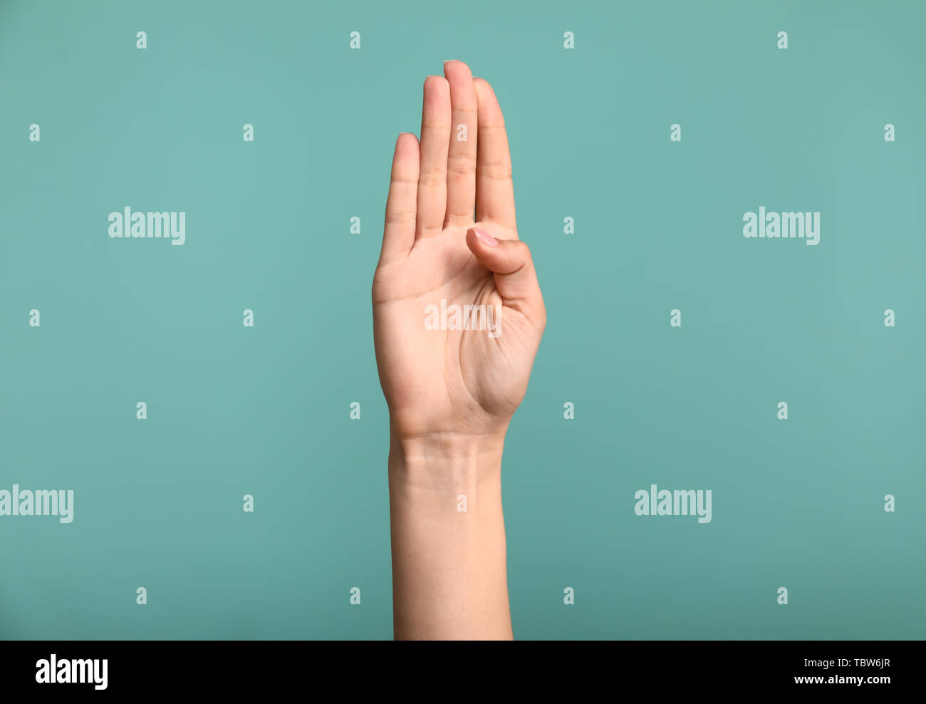 Female hand showing letter B on color background Stock Photo - Alamy