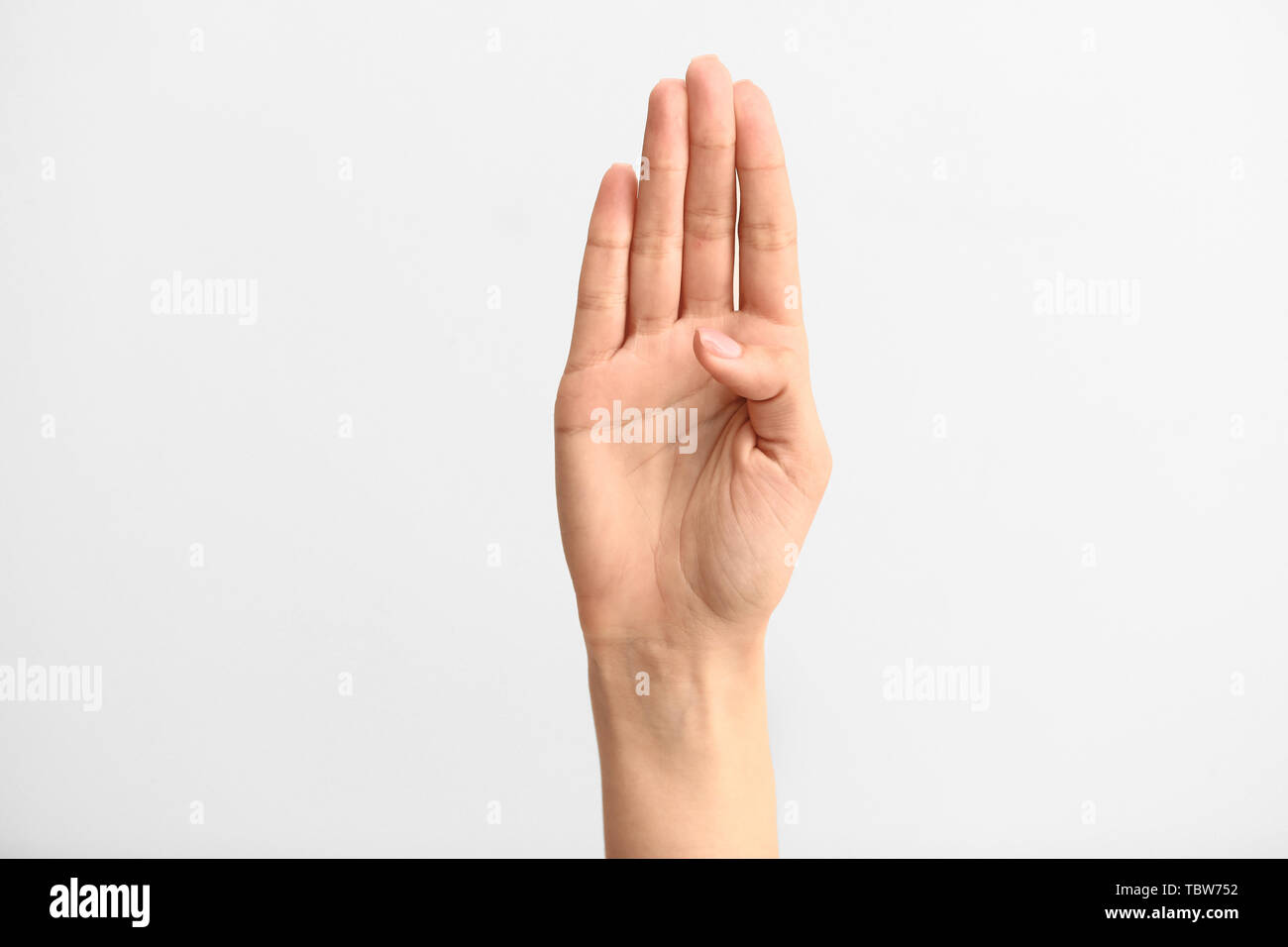 Female hand showing letter B on light background Stock Photo - Alamy