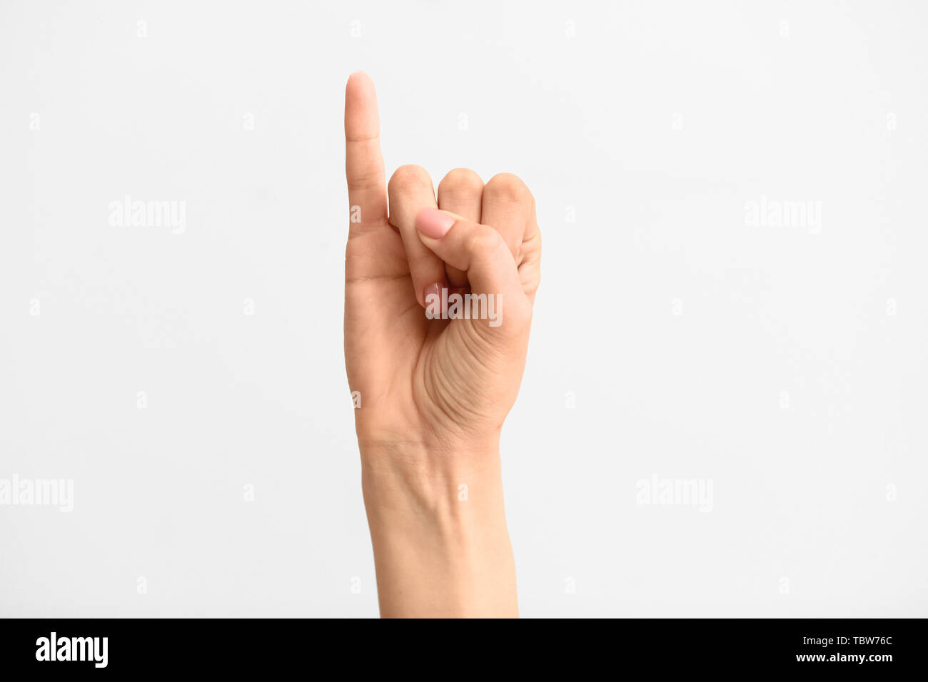 Female hand showing letter I on light background Stock Photo - Alamy