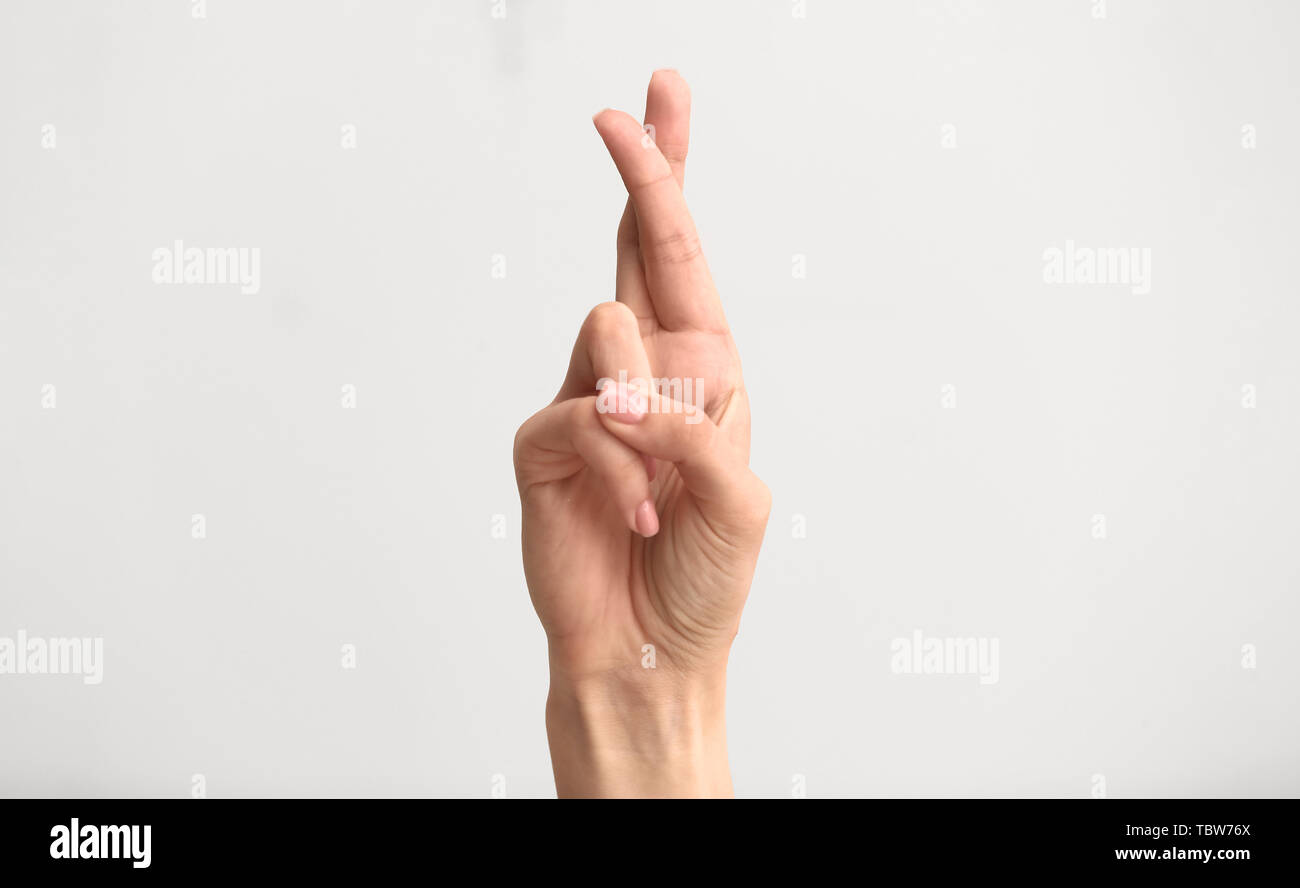 Female hand showing letter R on light background Stock Photo - Alamy