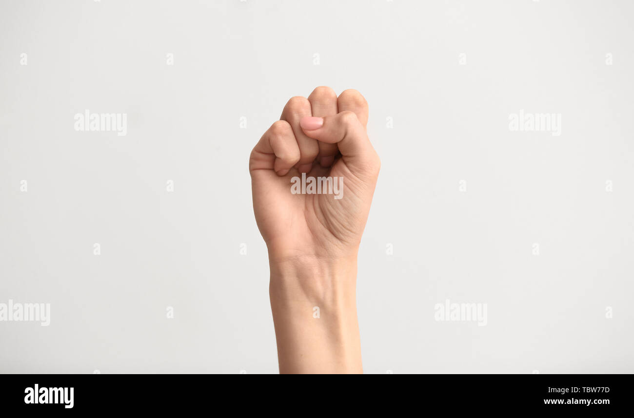 Female hand showing letter S on light background Stock Photo - Alamy