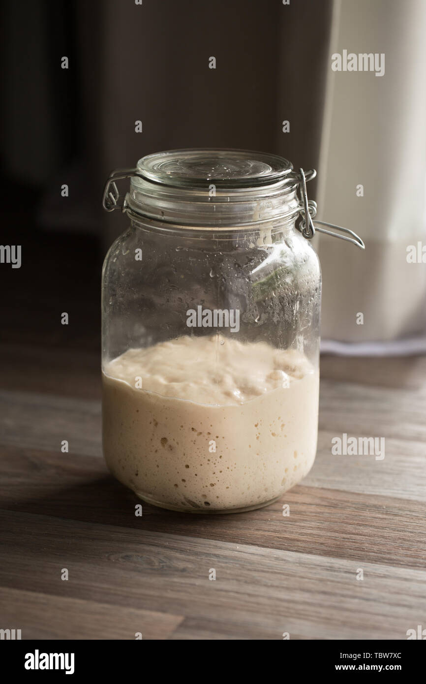 Making Natural Yeast Step 6 Natural yeast in a glass jar with a wooden ...