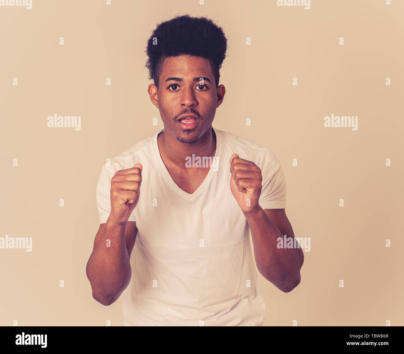 Portrait of young african american man feeling scared and shocked ...