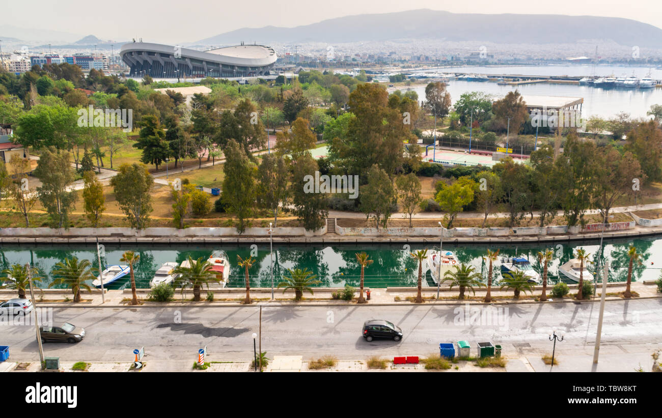 A picturesque view of a water canal running alongside a busy highway in ...