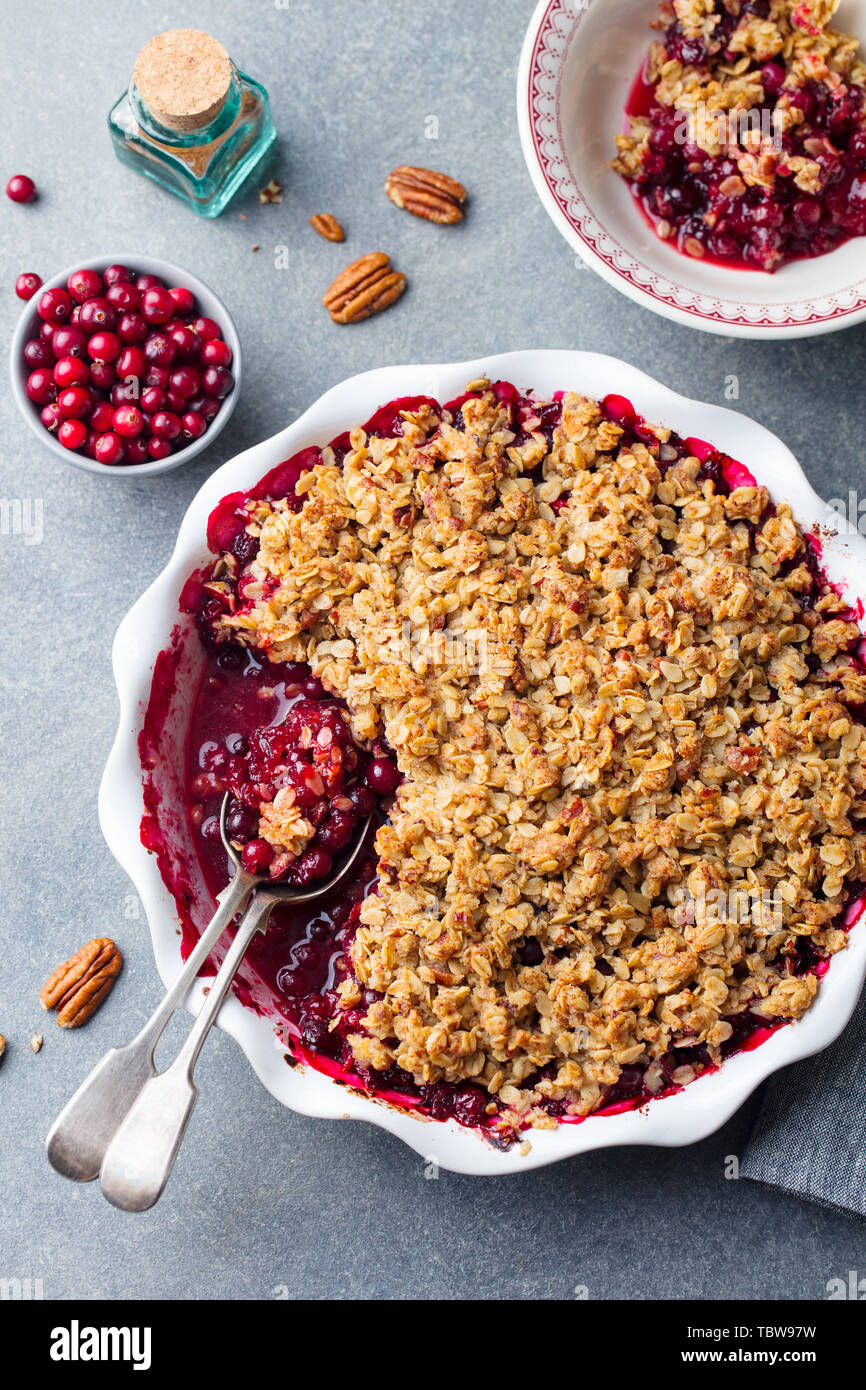 Cranberry crumble, crisp in a baking dish. Grey background. Top view ...