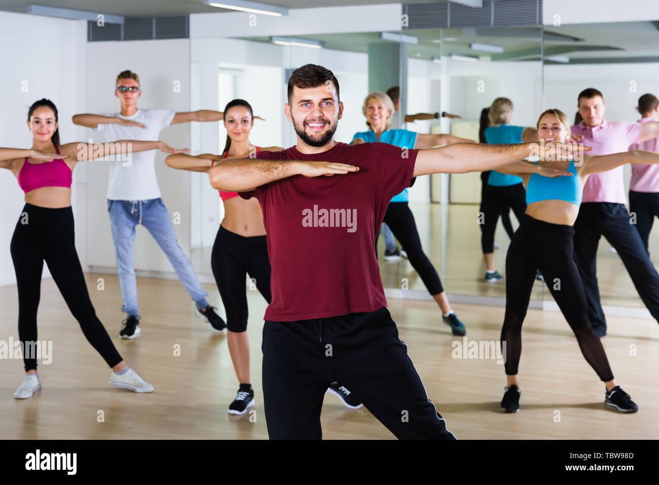 joyous men women of different ages posing in fitness studio Stock Photo ...