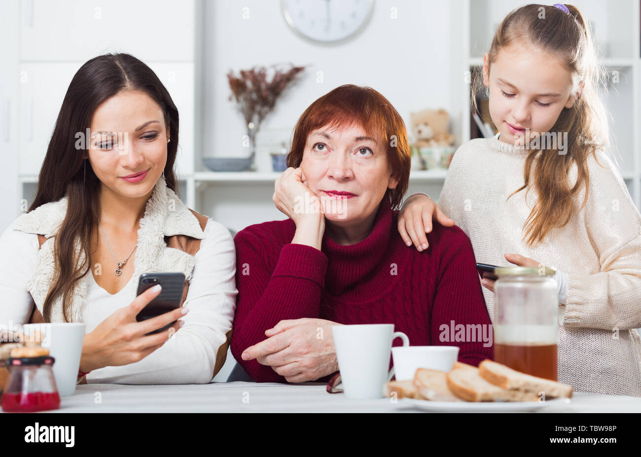 Family Using Phones Table High Resolution Stock Photography and Images ...