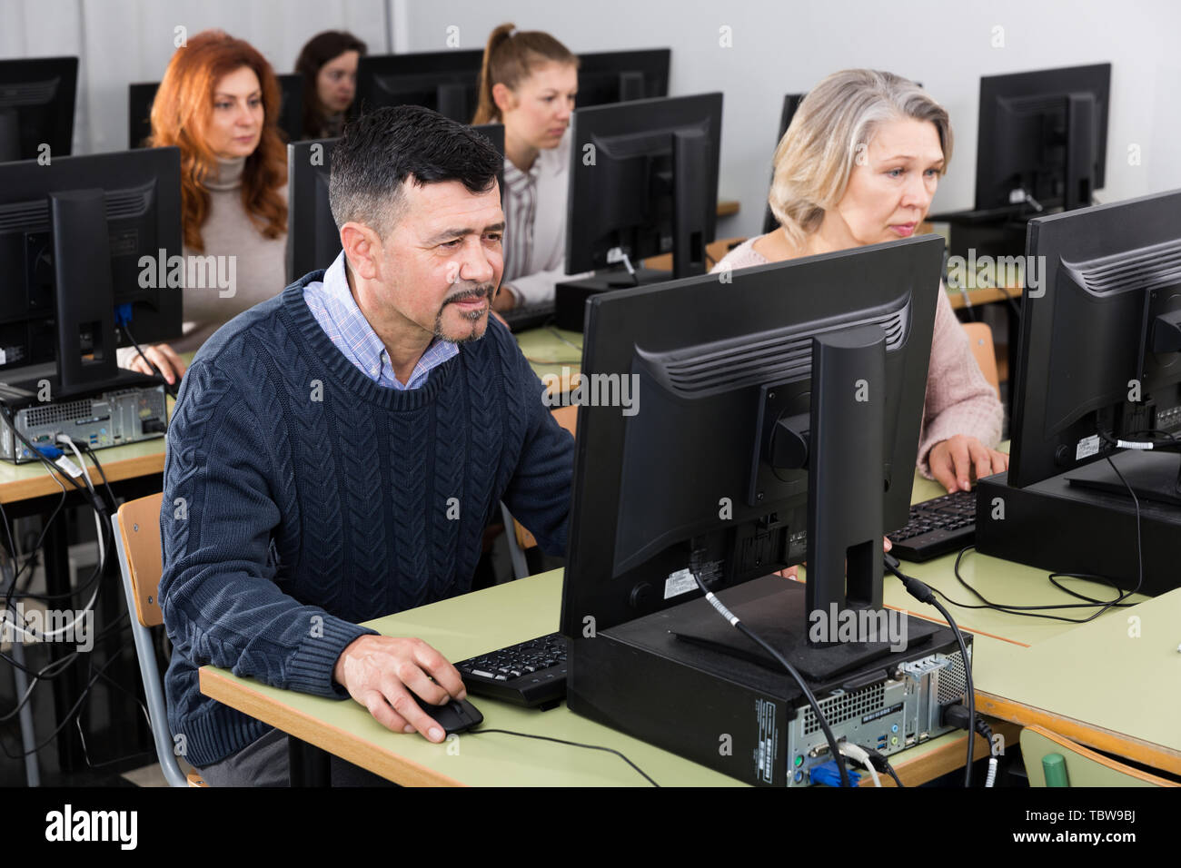 Portrait of focused mature man during computer classes at university of ...