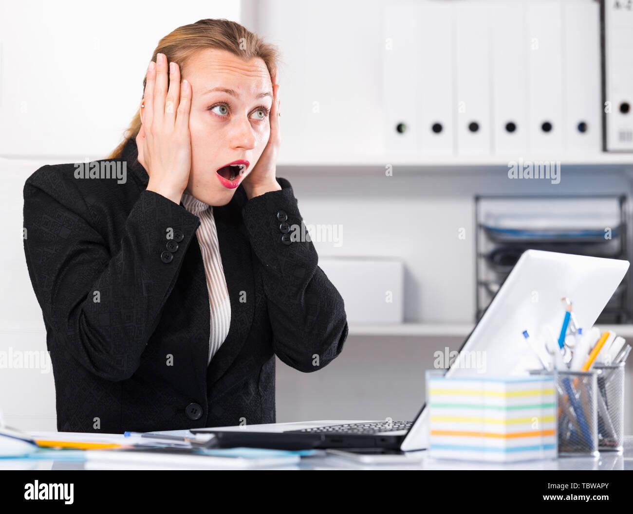 Young female having lot of work in the office Stock Photo - Alamy