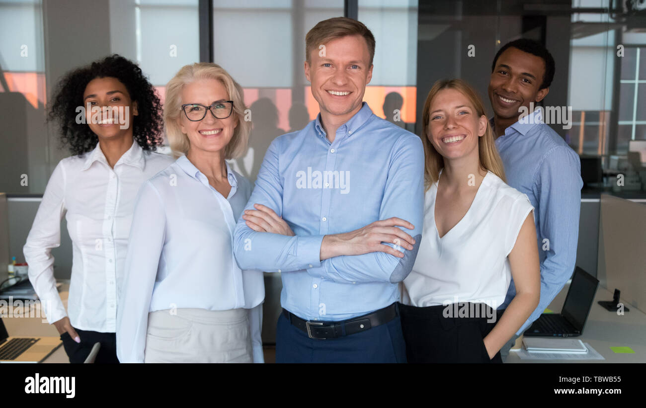 Successful team leader and diverse employees posing for photo together ...