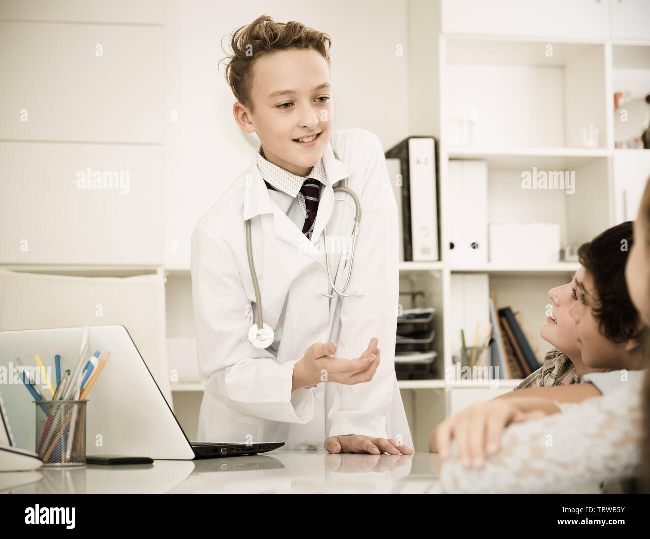Medical brother boy in medical center with stethoscope with visitors ...