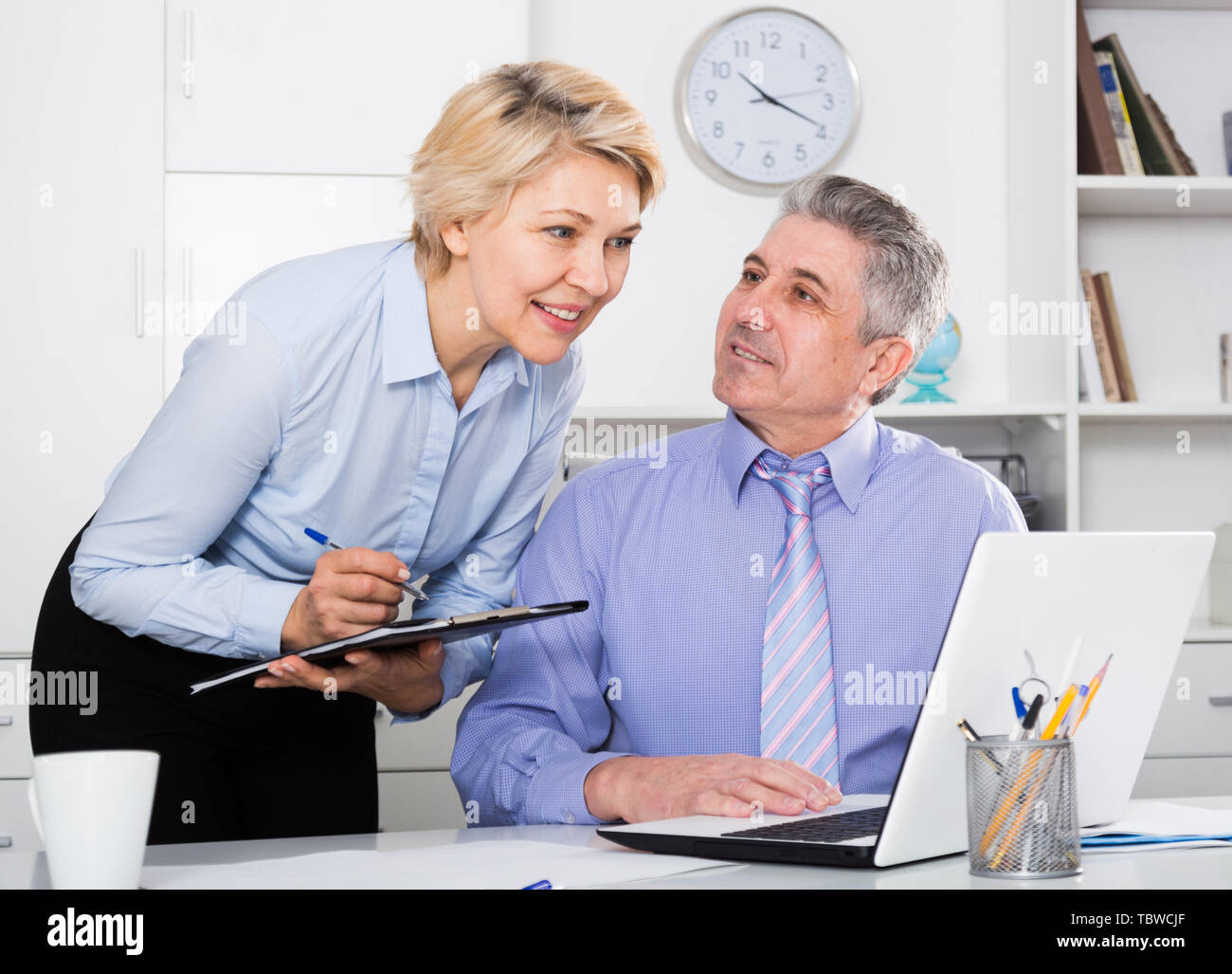 Director's assistant makes daily routine and writes down instructions ...