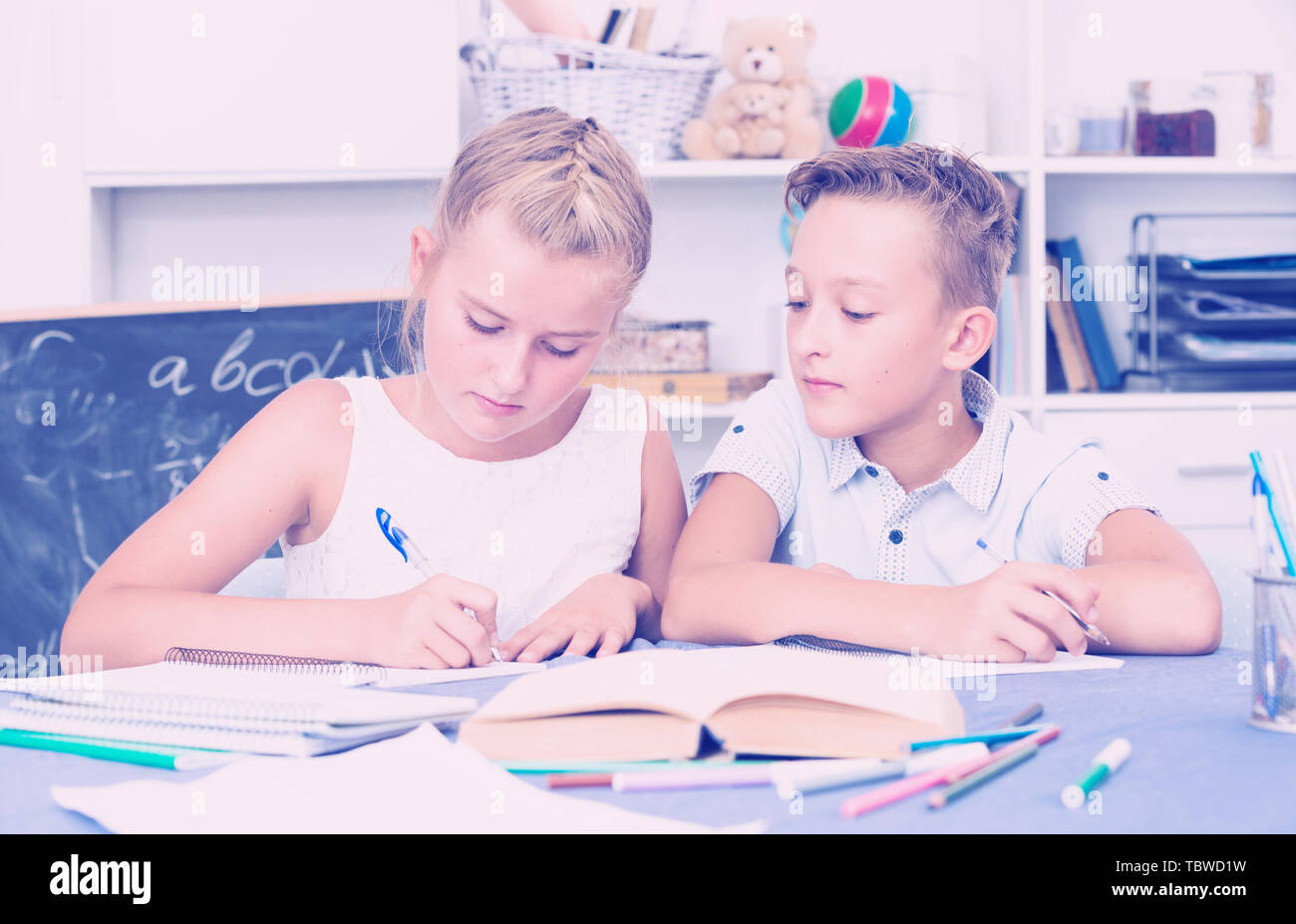 Brother with sister are doing homework at home Stock Photo - Alamy