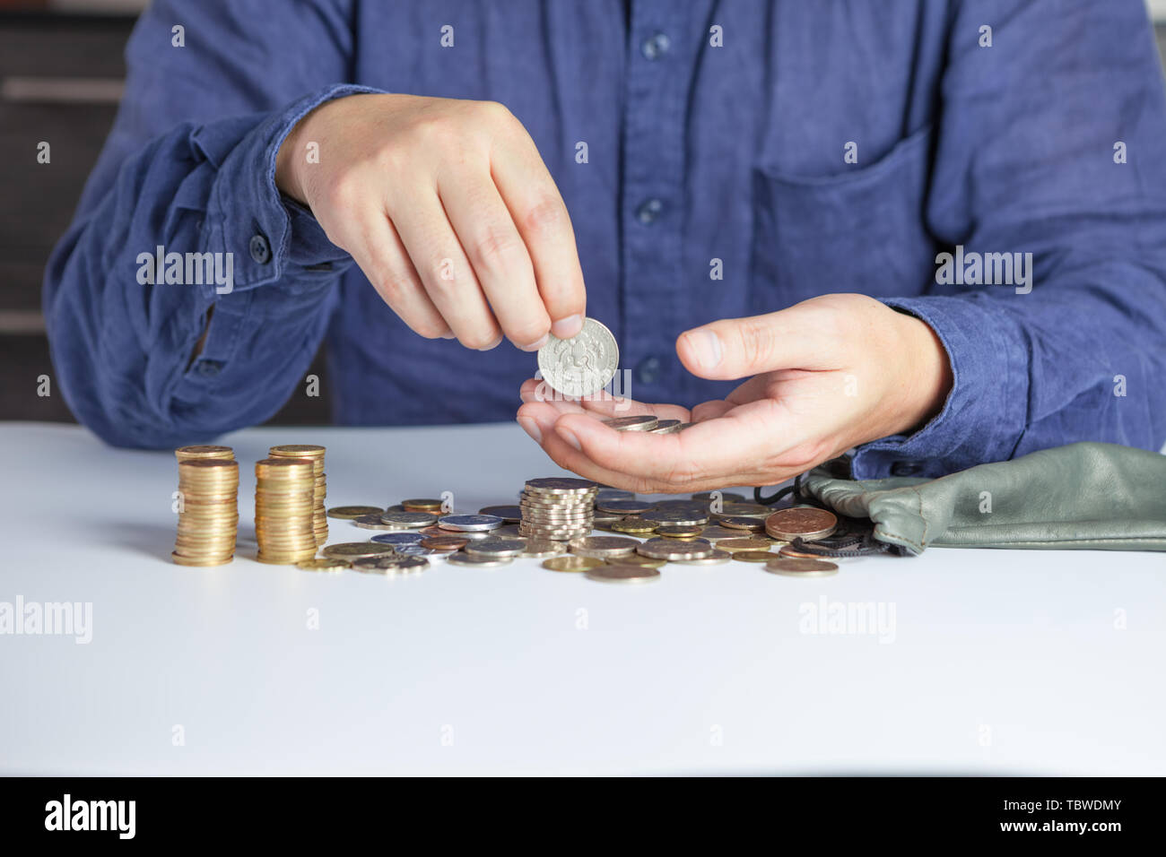 Hand sorting coins hi-res stock photography and images - Alamy