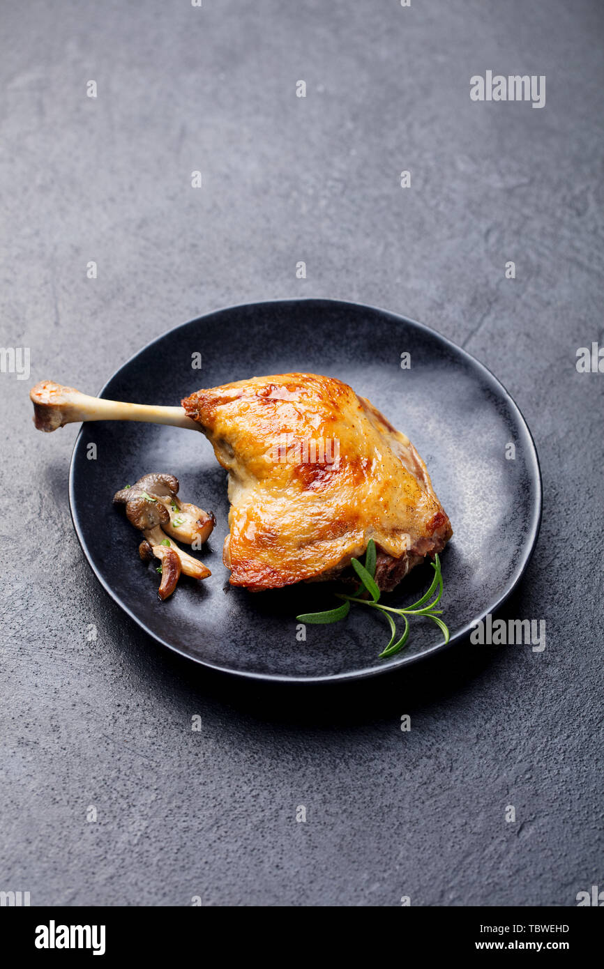 Duck legs confit with mushroom sauce . Restaurant serving. Copy space ...