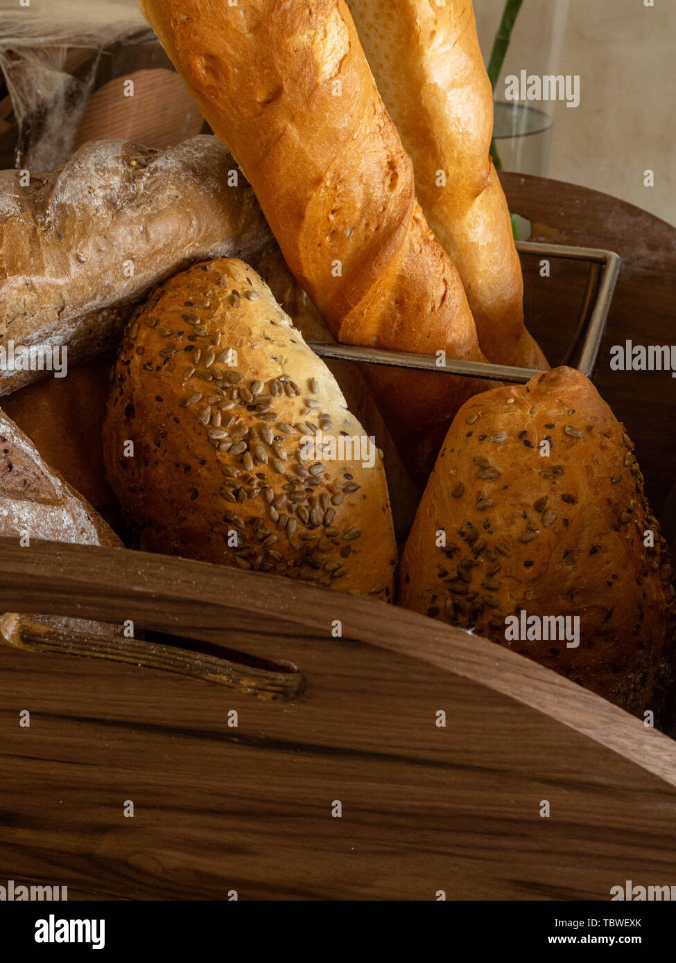 assortment of baked bread on wood box, many types of bread close up ...