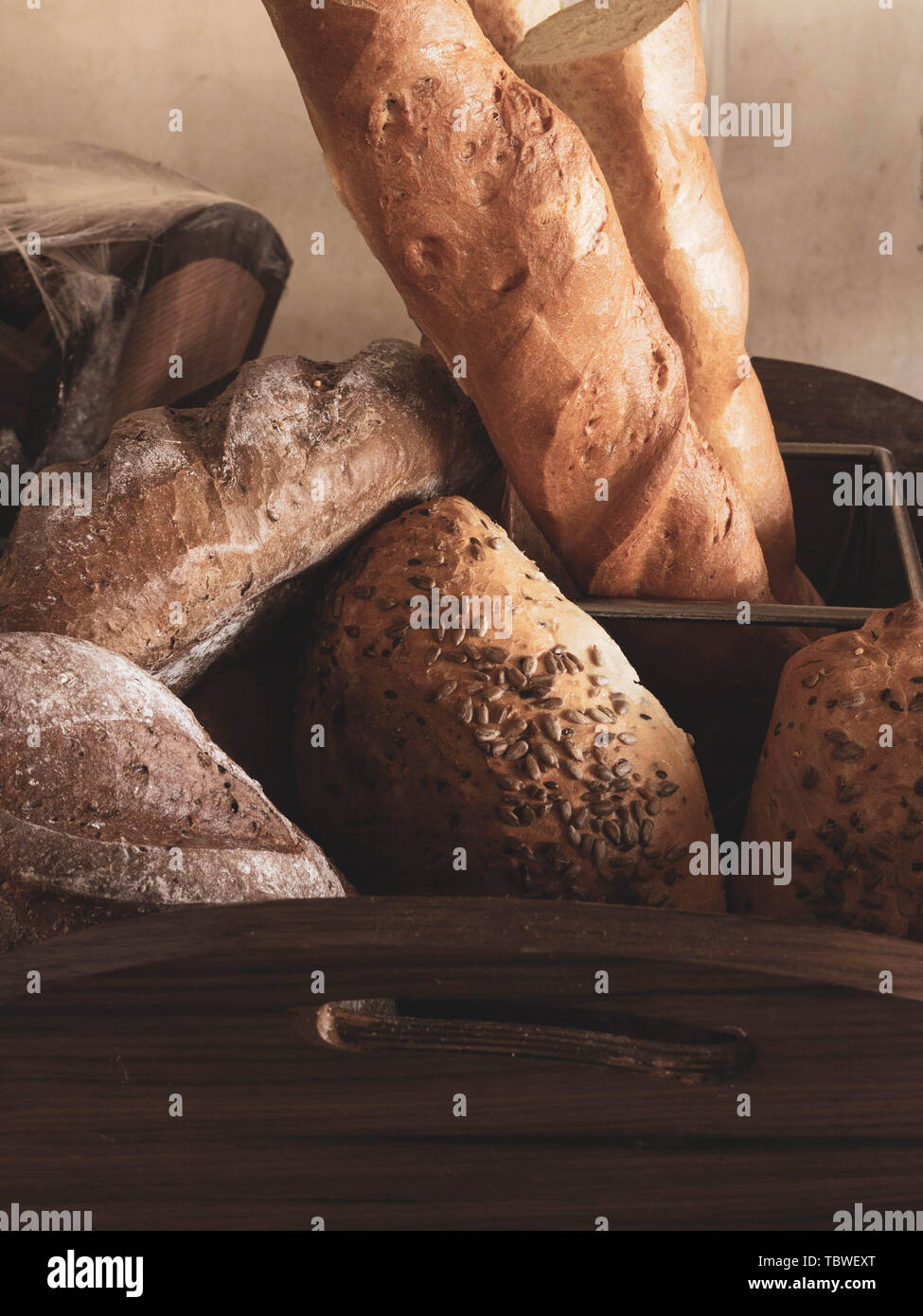 assortment of baked bread on wood box, many types of bread close up ...