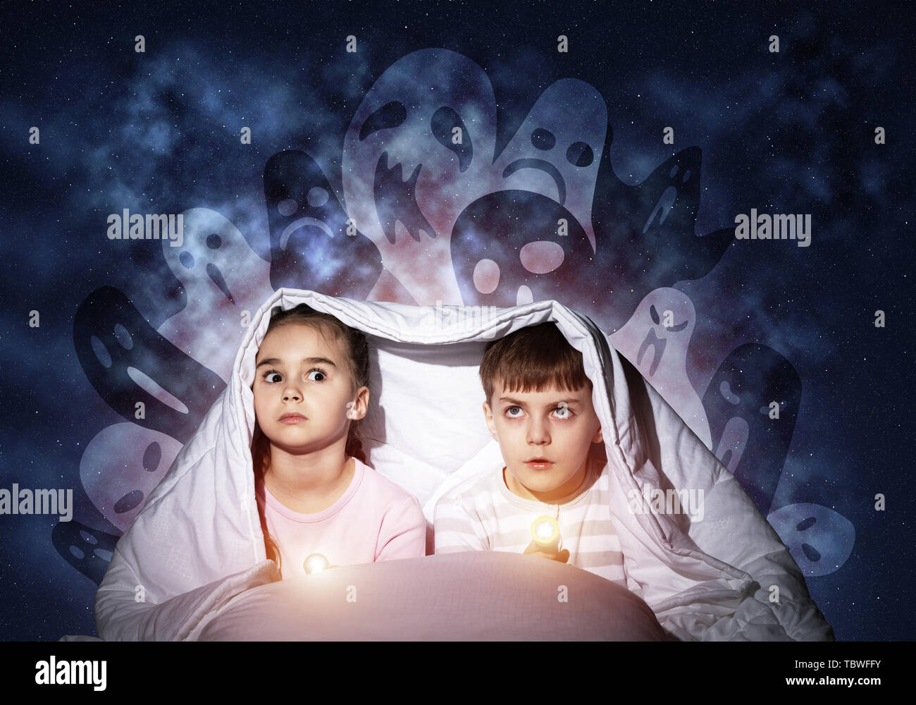 Scared sister and brother with flashlights Stock Photo - Alamy