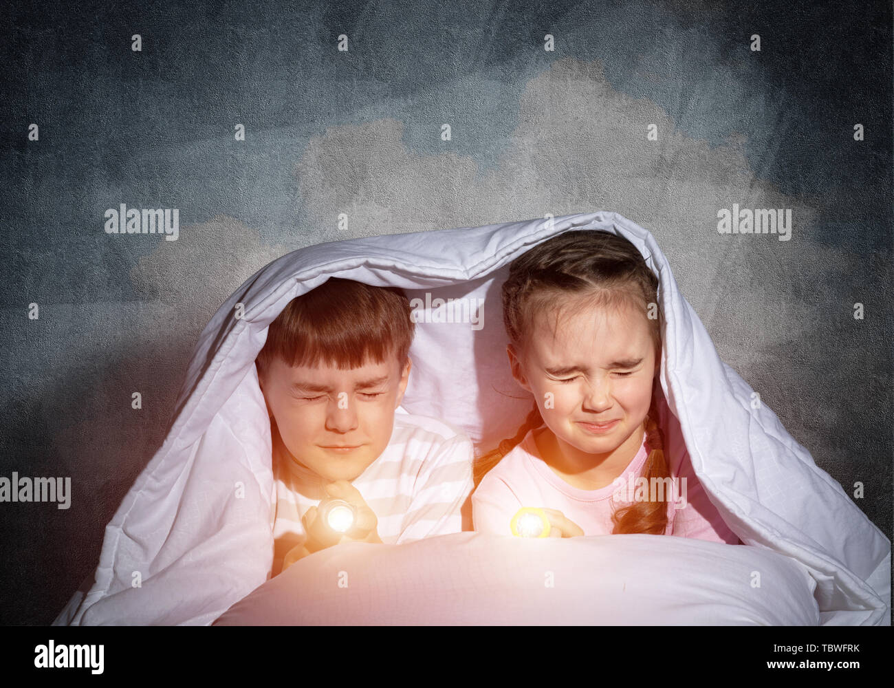 Children with flashlight in bed Stock Photo - Alamy