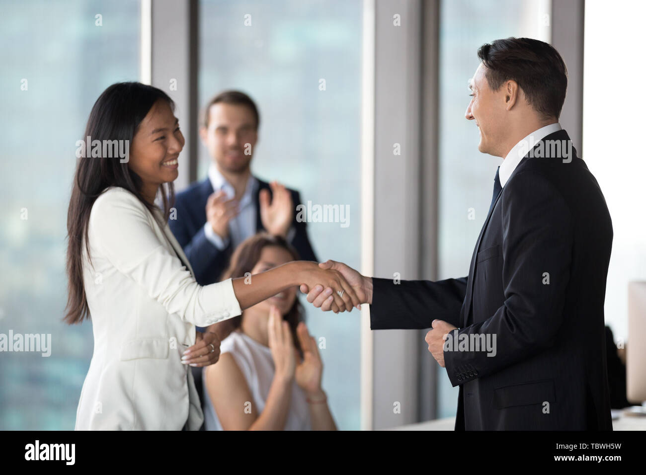 Company CEO handshake female employee greeting with achievement Stock ...