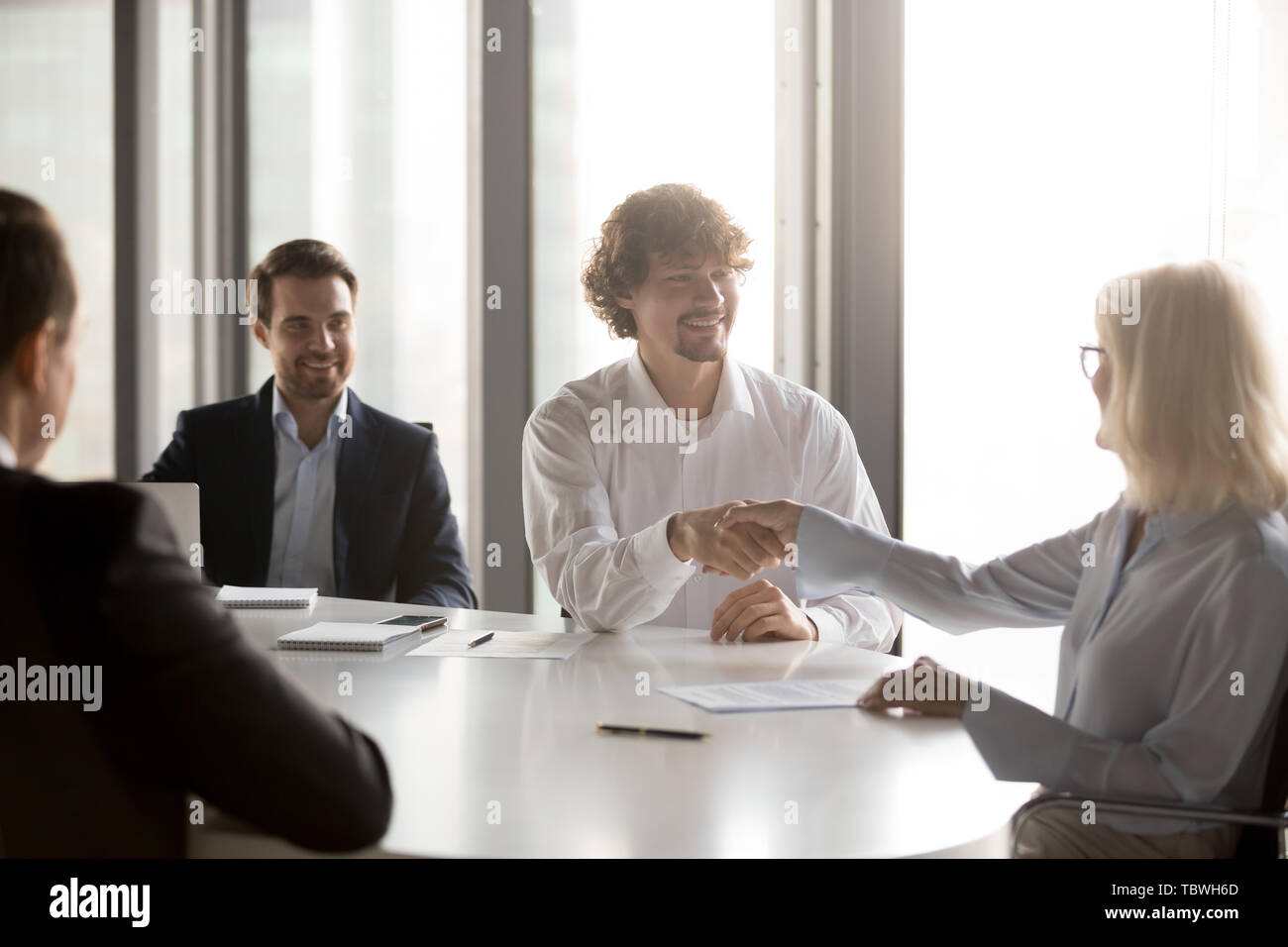 Happy business partners handshake closing successful deal Stock Photo ...
