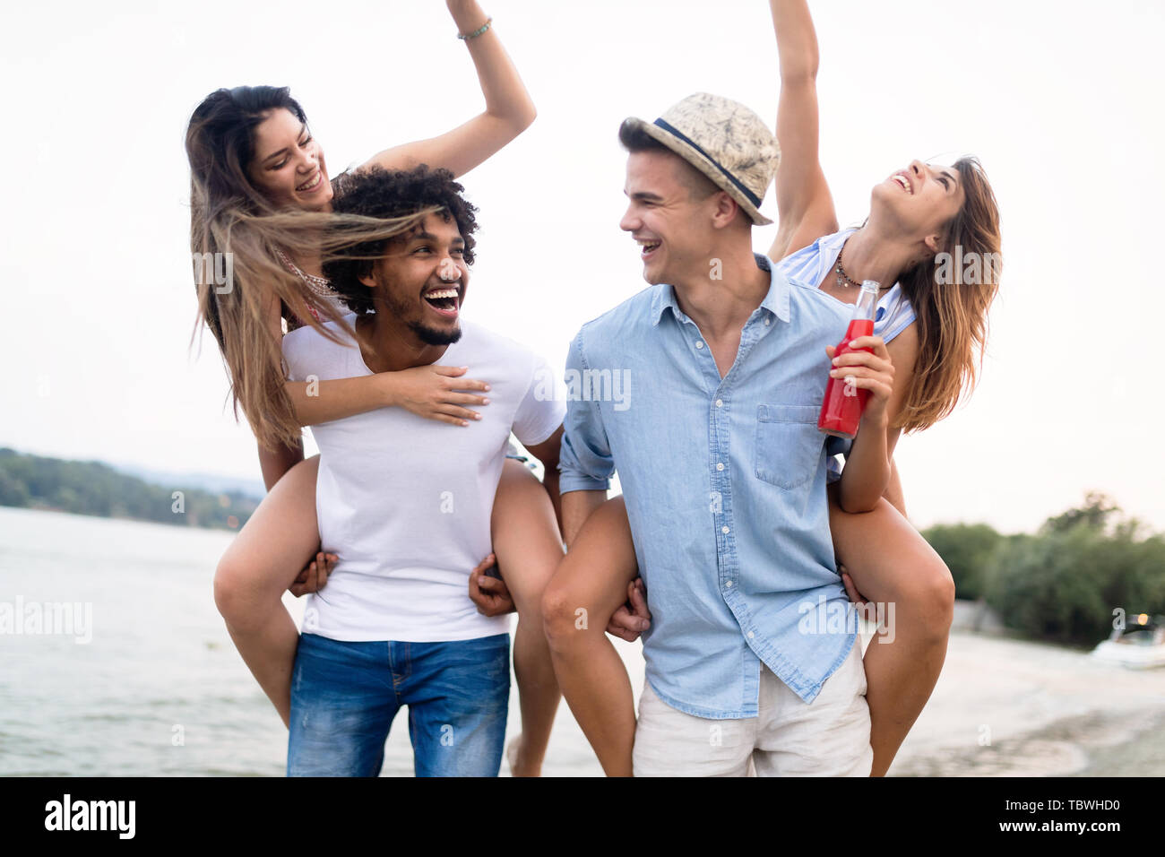 Group of friends having fun on the beach hi-res stock photography and ...