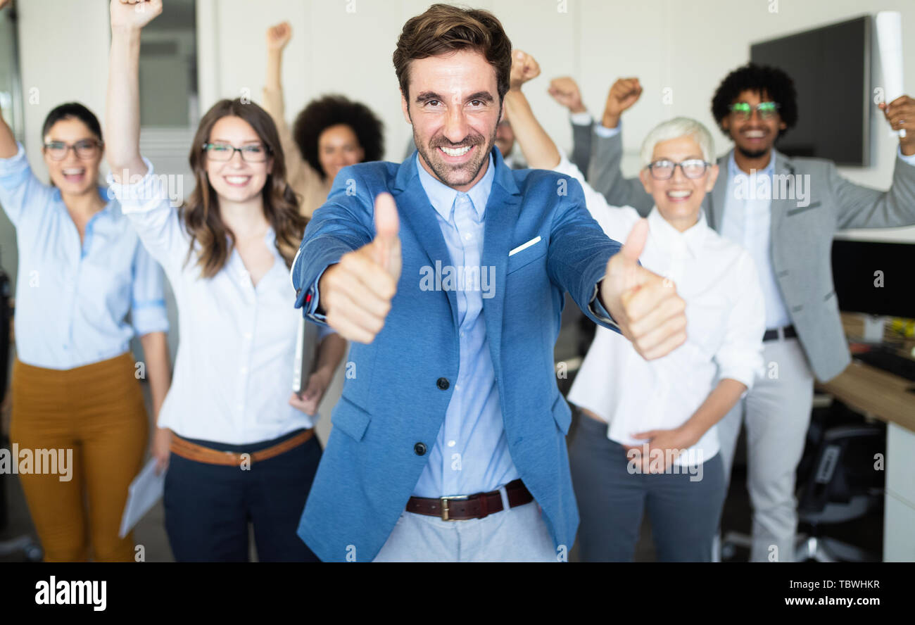 Happy business people celebrating success at company Stock Photo - Alamy