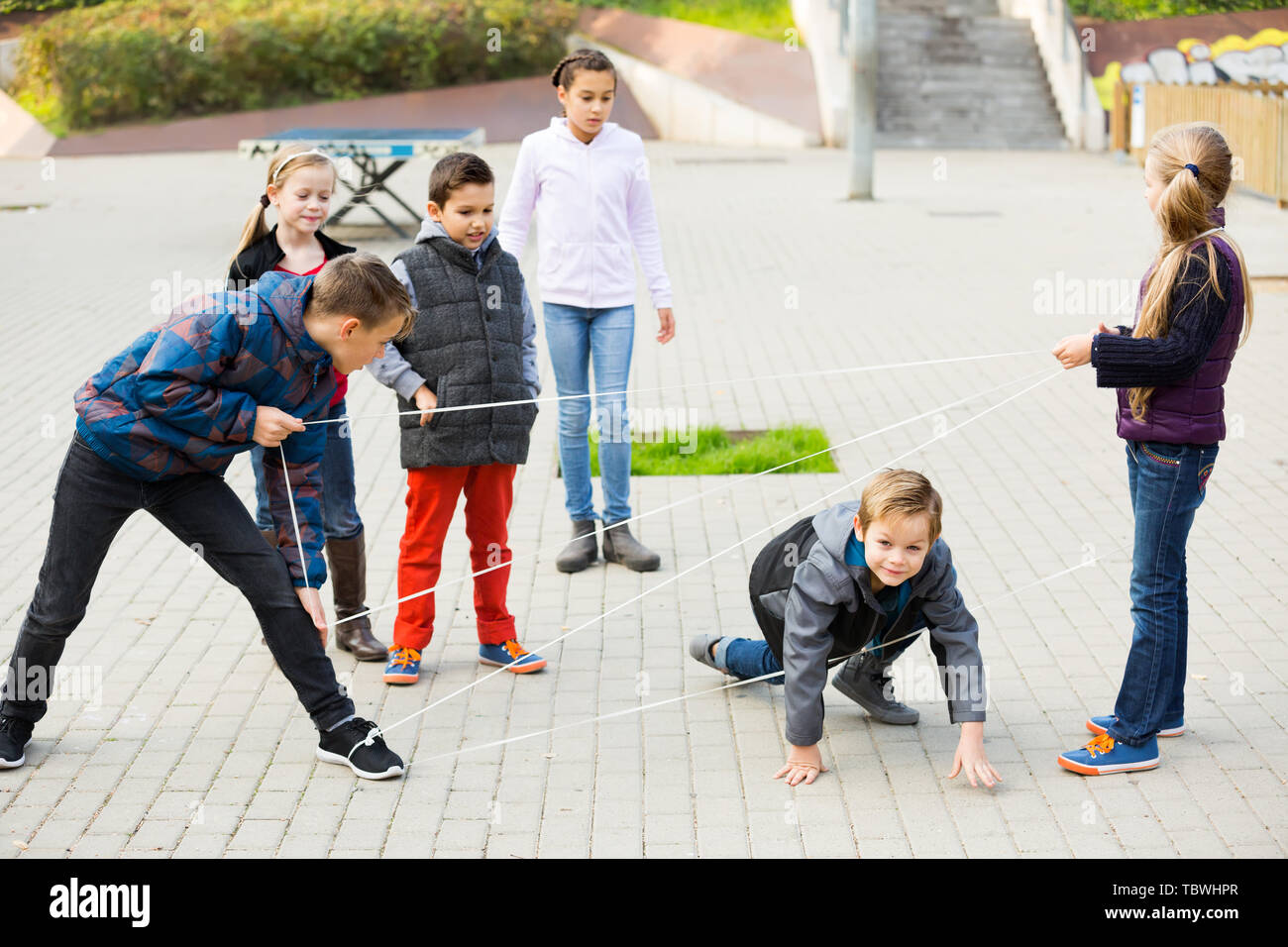 Boy gently passes through the tangled rope Stock Photo - Alamy