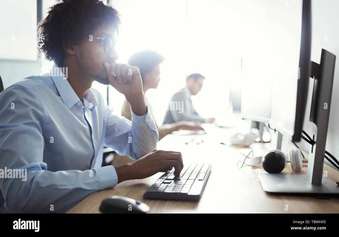 Programmer working in a software developing company office Stock Photo ...