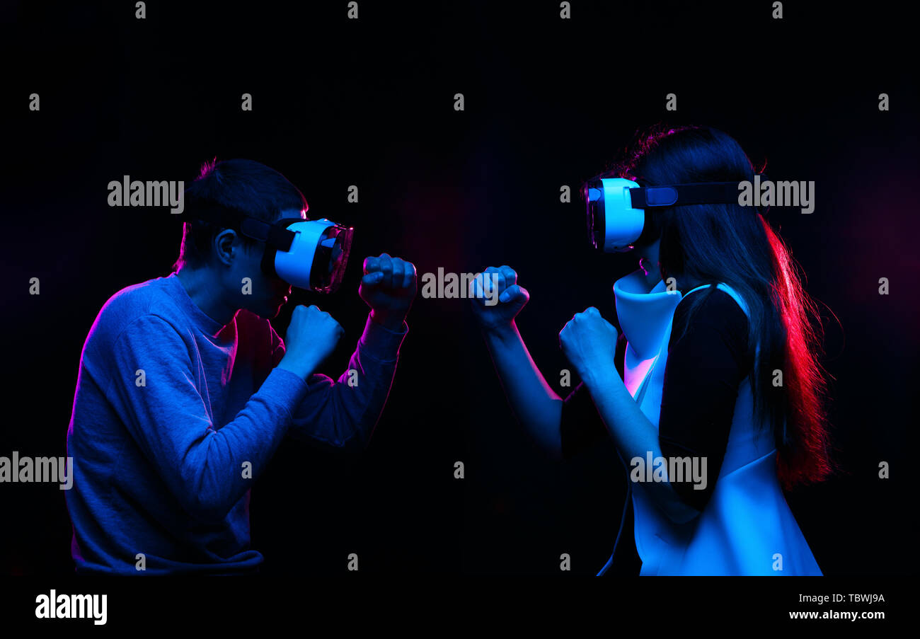 Couple with virtual reality headset are playing game and fighting Stock ...