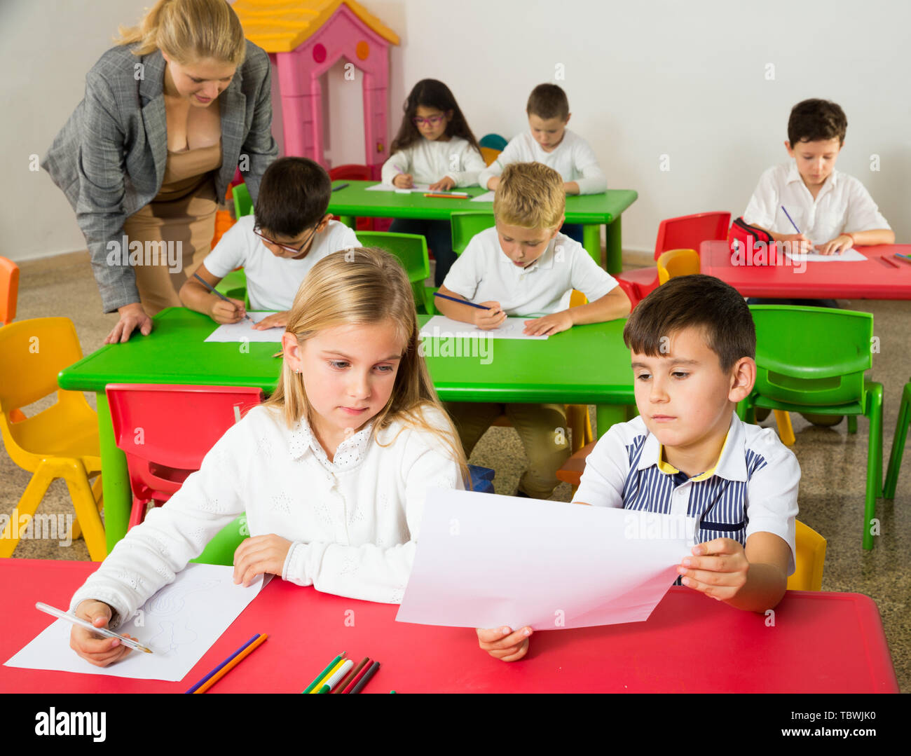 Elementary students chatting during class hi-res stock photography and ...