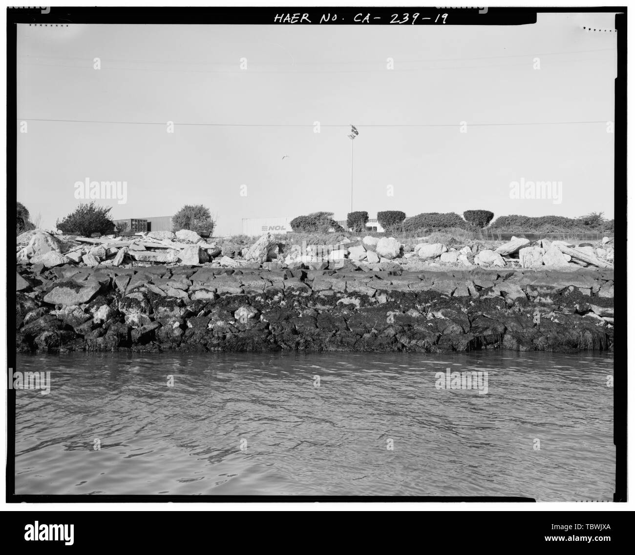 MEDIUM DISTANCE VIEW OF NORTH TRAINING WALL FROM THE WATER, LOOKING ...