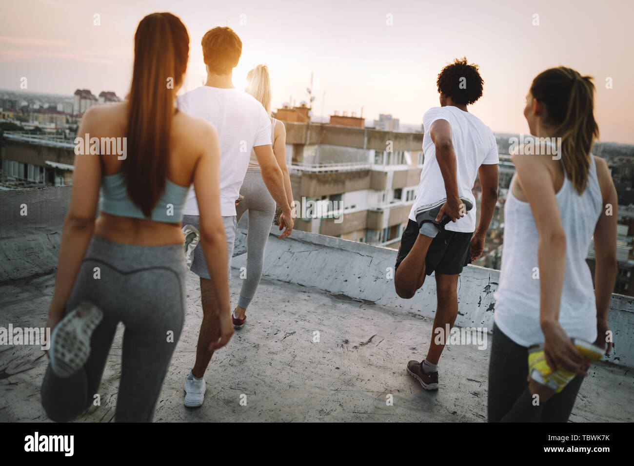 Group of fit healthy friends, people exercising together outdoor on ...