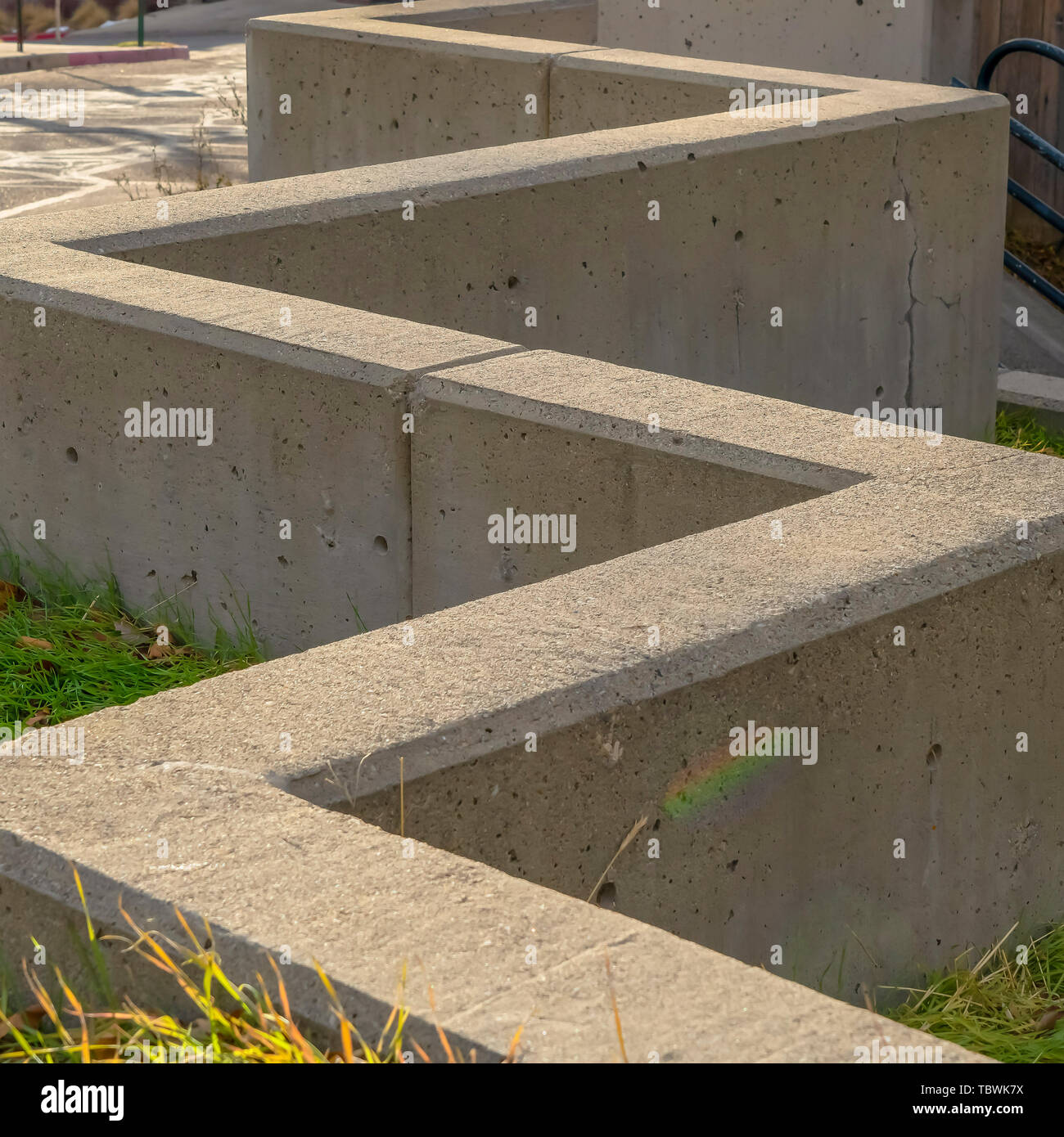 Square frame Concrete blocks on a grassy terrain at the side of a road ...
