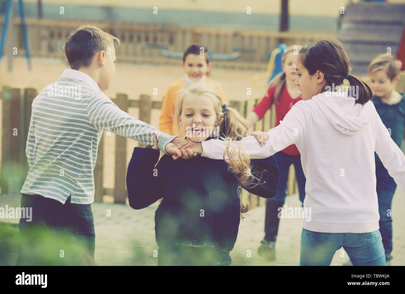 Positive kids full of energy playing forcing the city gates Stock Photo ...